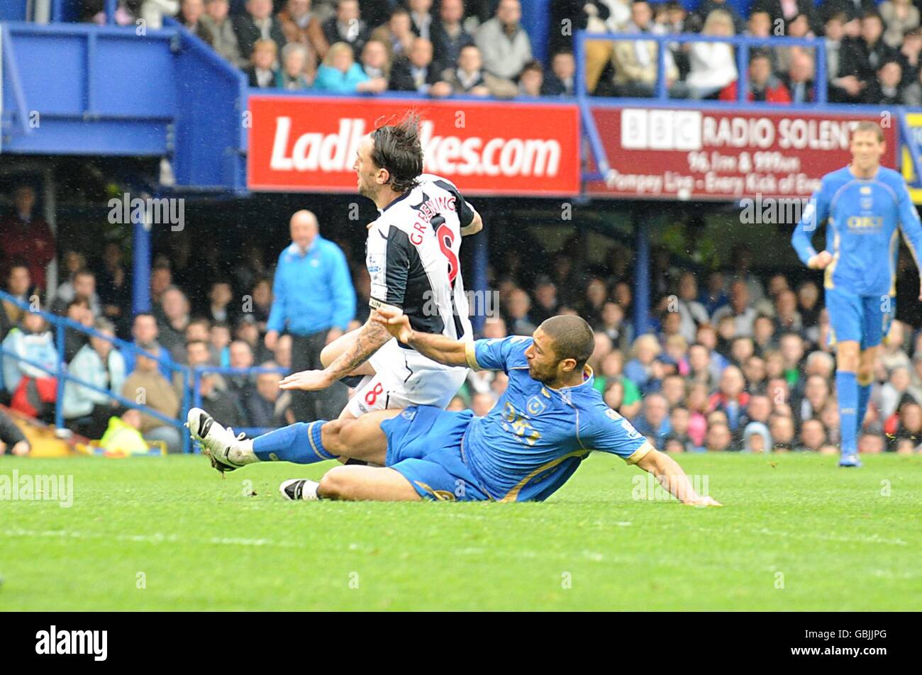 West Bromwich Albion's Jonathan Greening (centre) is brought down by ...