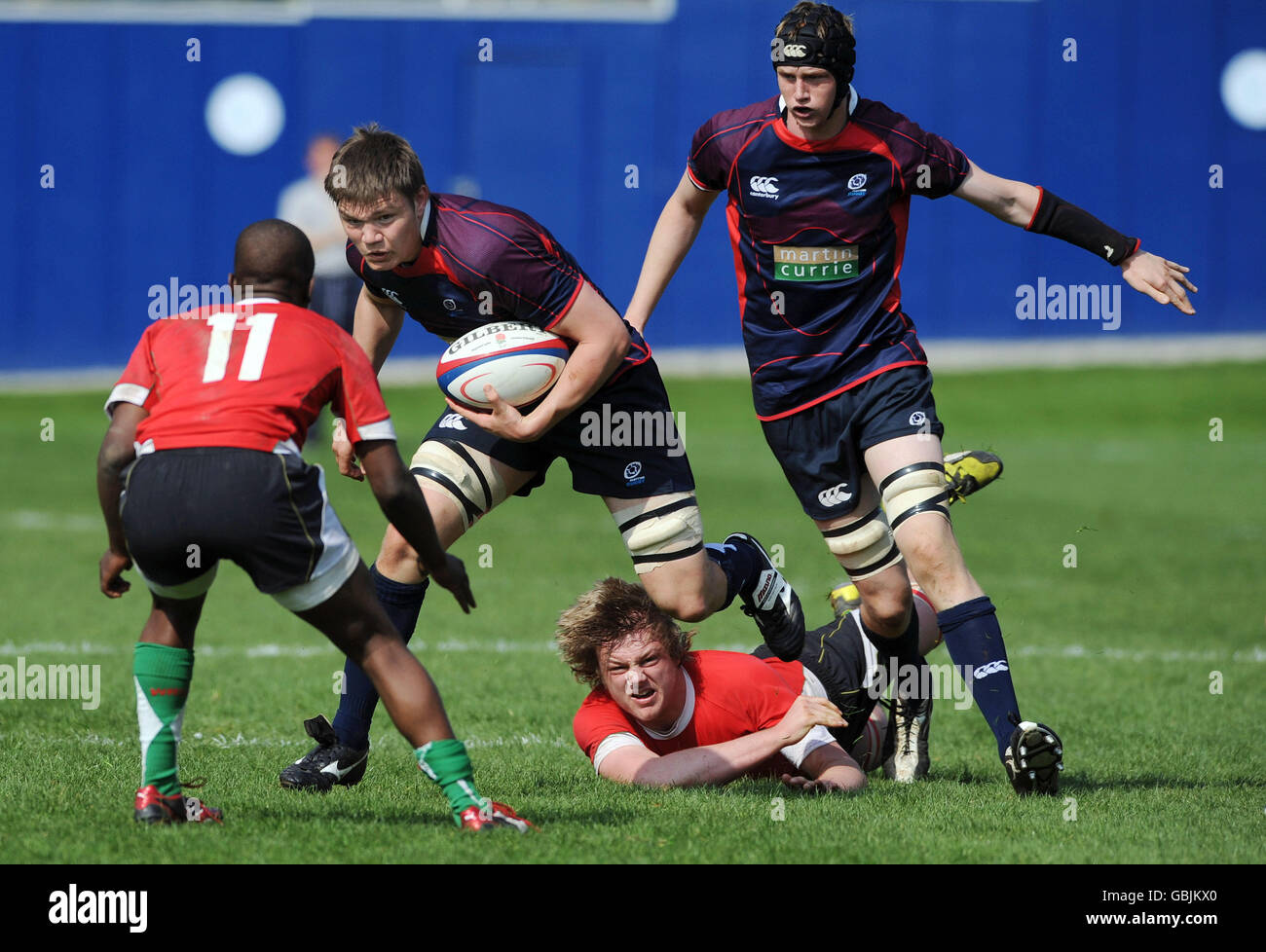 Scotland's Jamie Swanson (centre) fights his way through the Welsh line ...