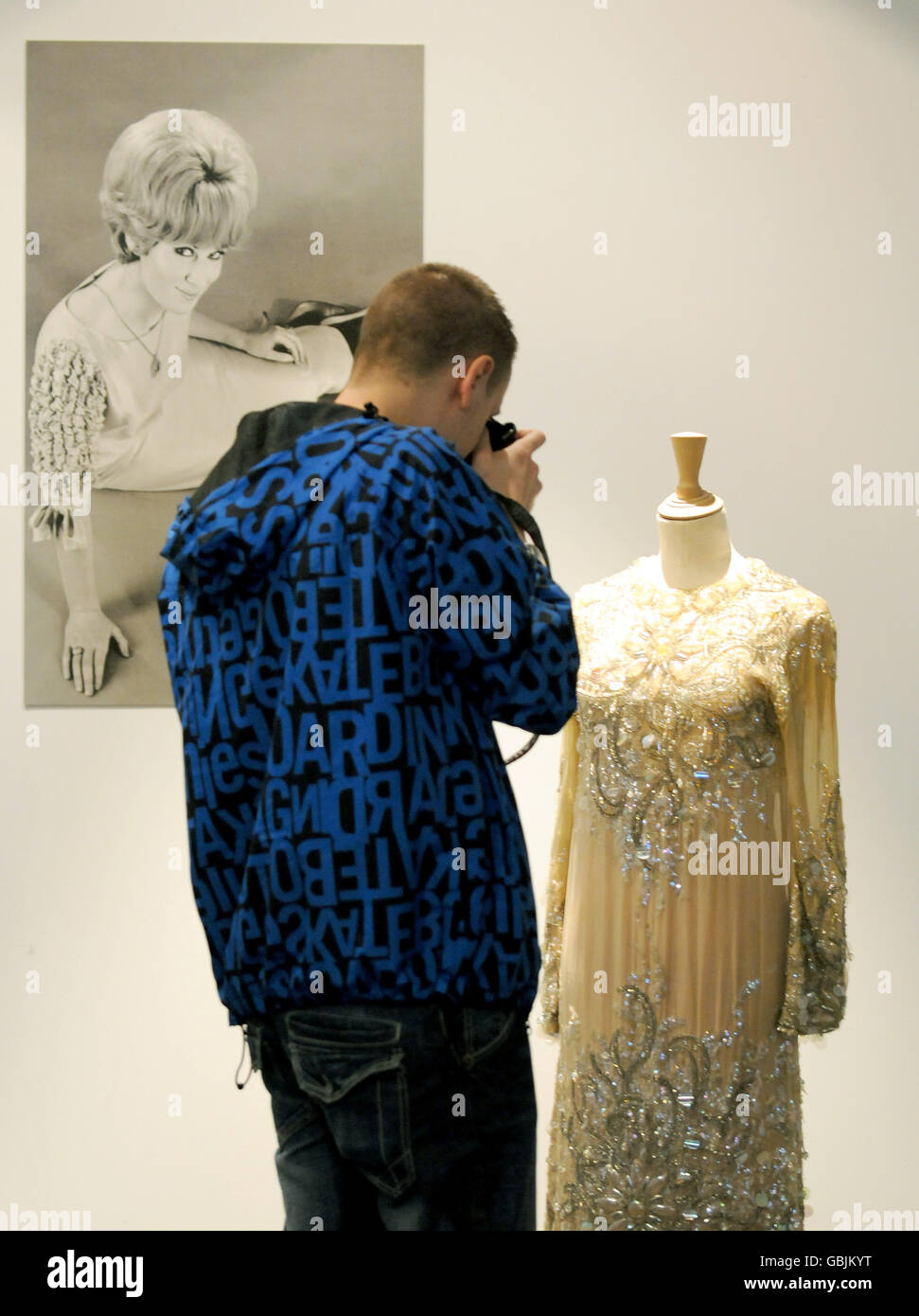 A man photographs the dress worn on the cover of the album Dusty ...