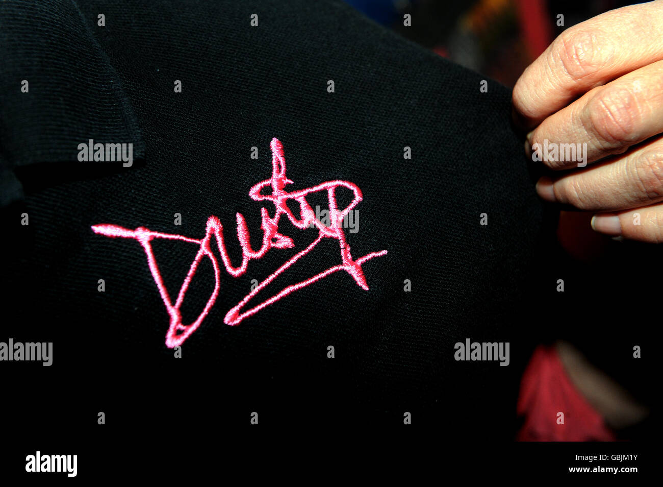A fan wears a t-shirt bearing a copy of the signature of Dusty ...