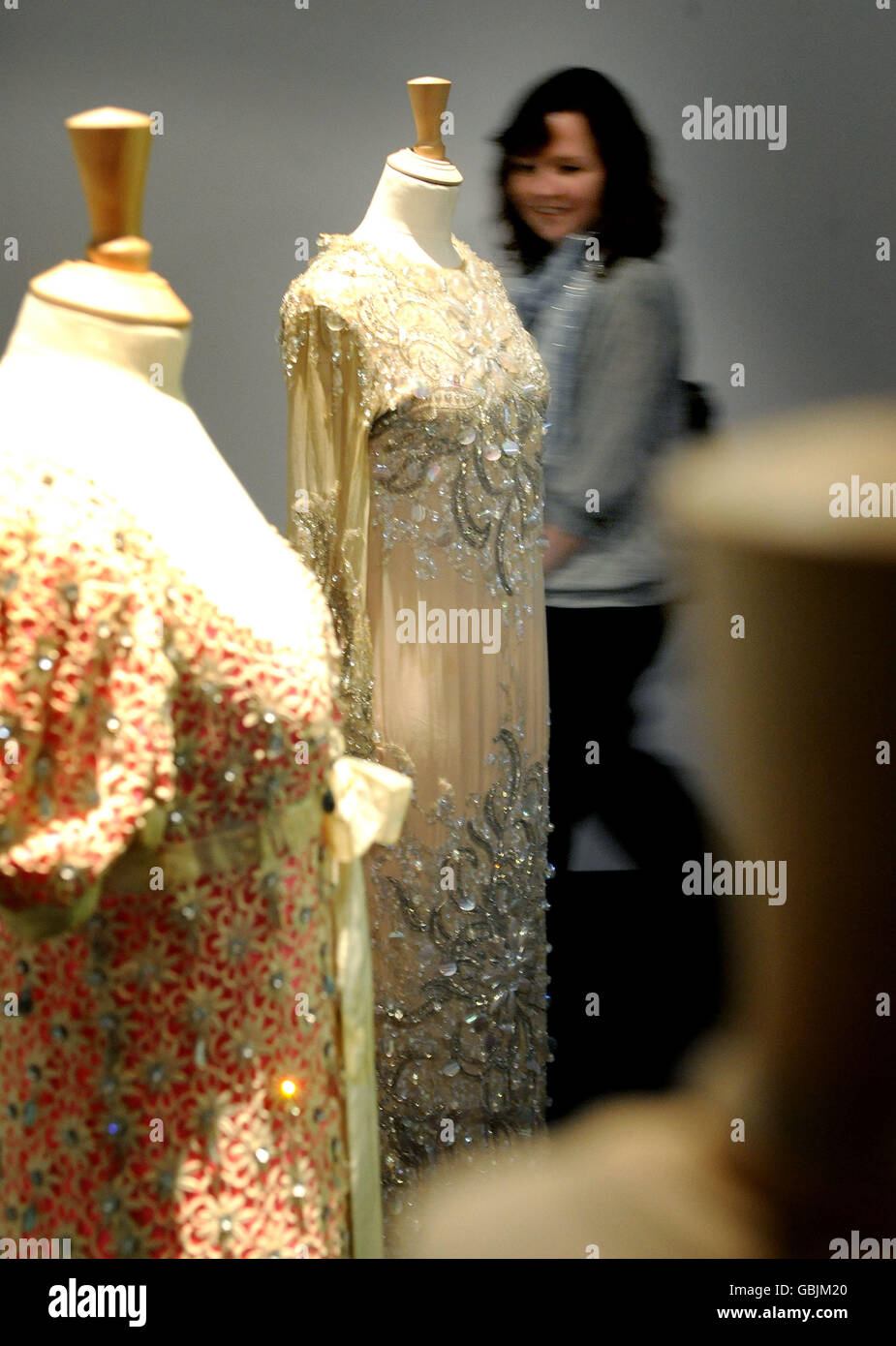 A woman looks at the dress worn on the cover of the album Dusty ...