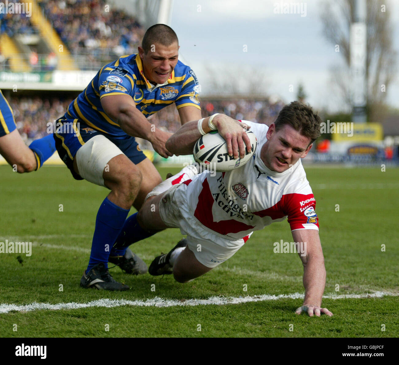 Matt Gidley scores a try for St. Helens under pressure from Leeds ...