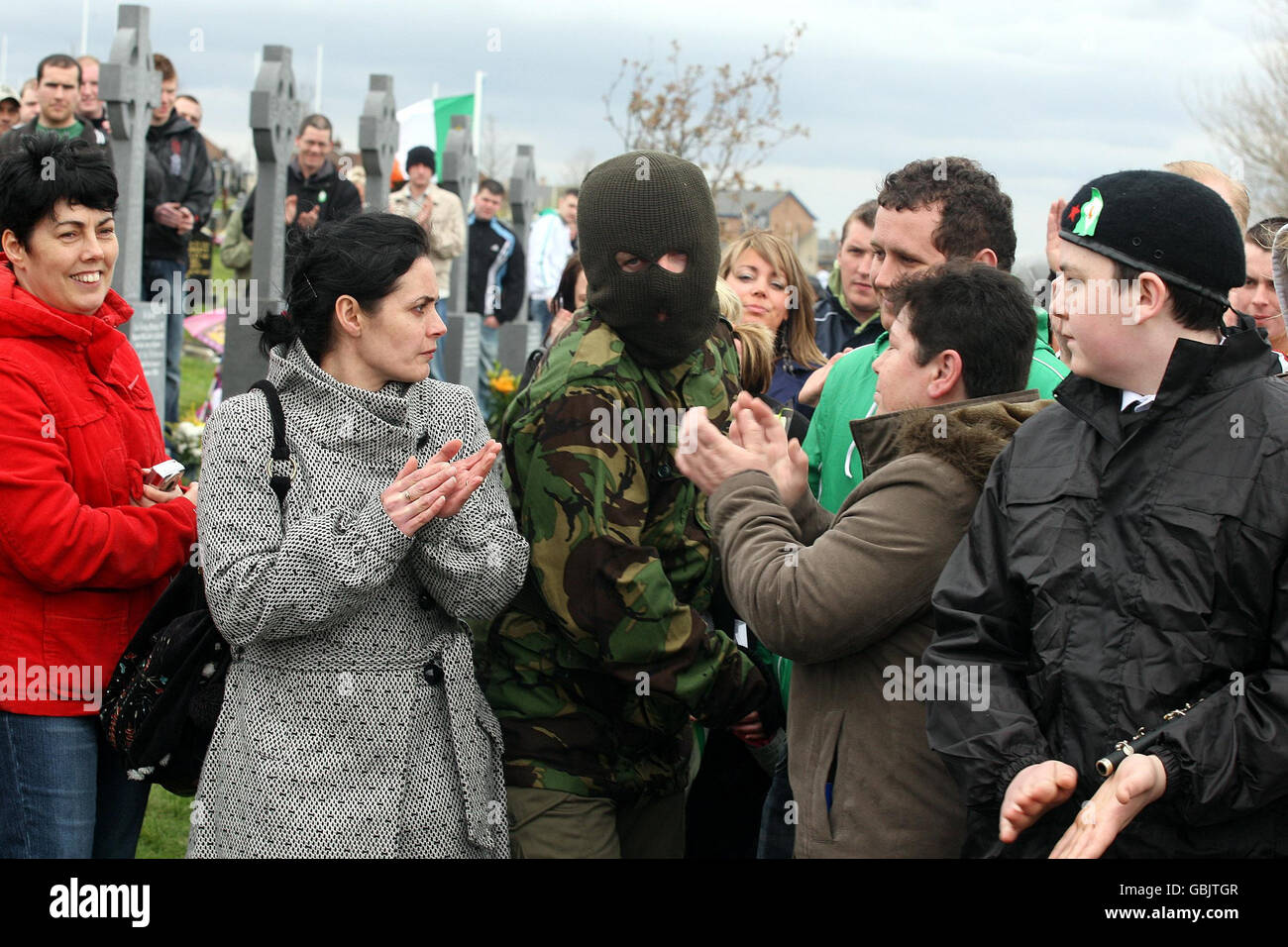 A masked Real IRA man appears from the crowd to read a statement, at a ...