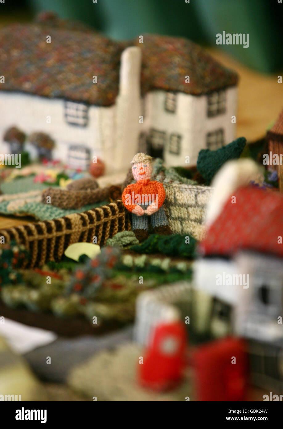 A villlager on the allotment, part of the Meresham Knitted Village. The ...