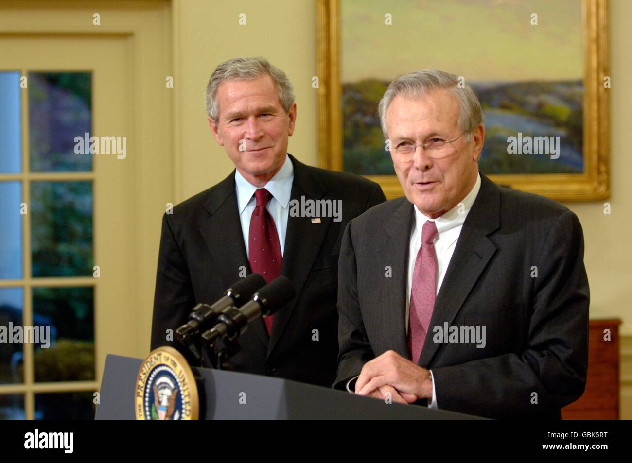 U S President George W Bush Looks On As Secretary Of Defense Donald
