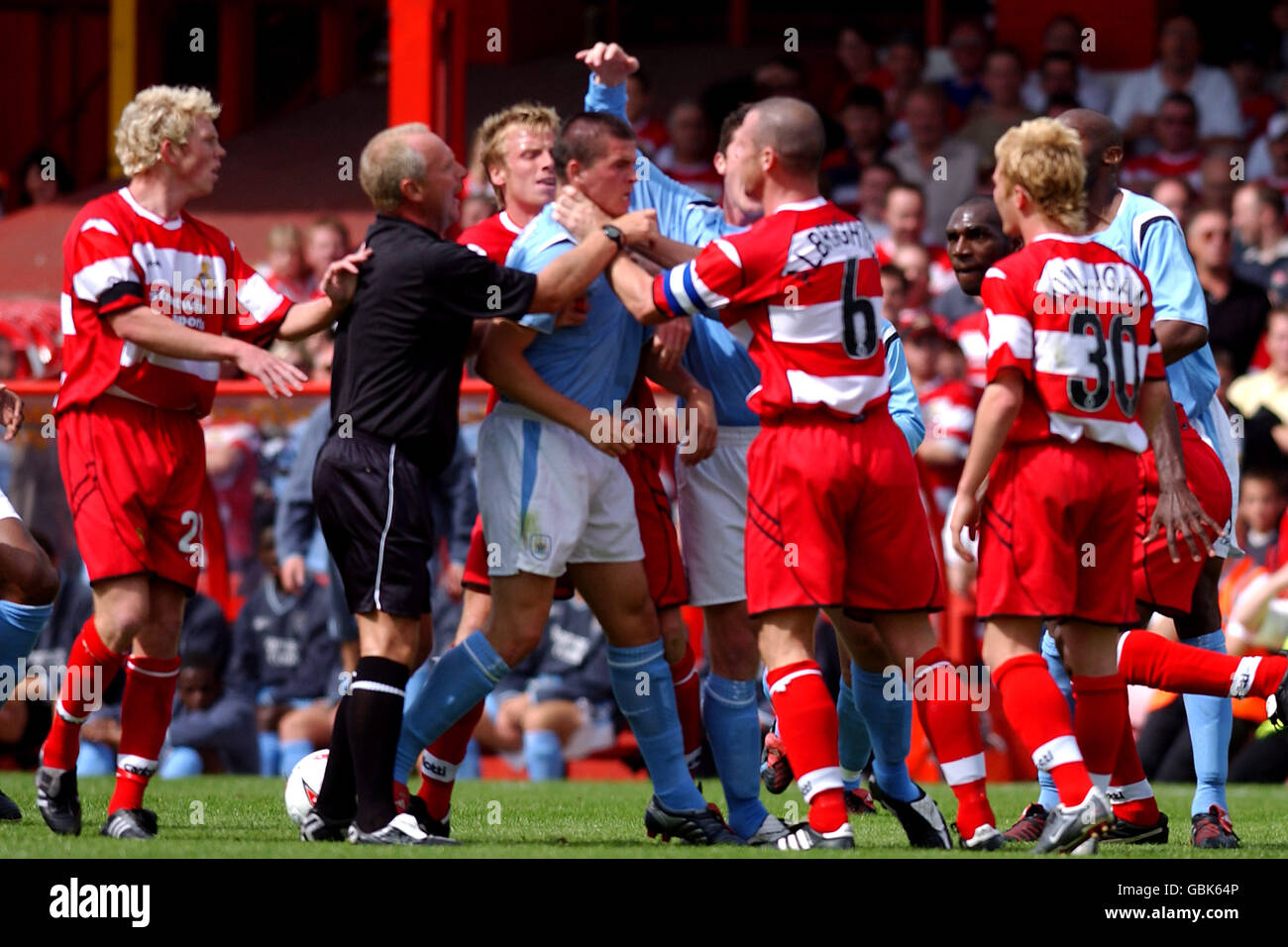 Doncaster Rovers' Mark Albrighton (r) gets to grips with Manchester ...