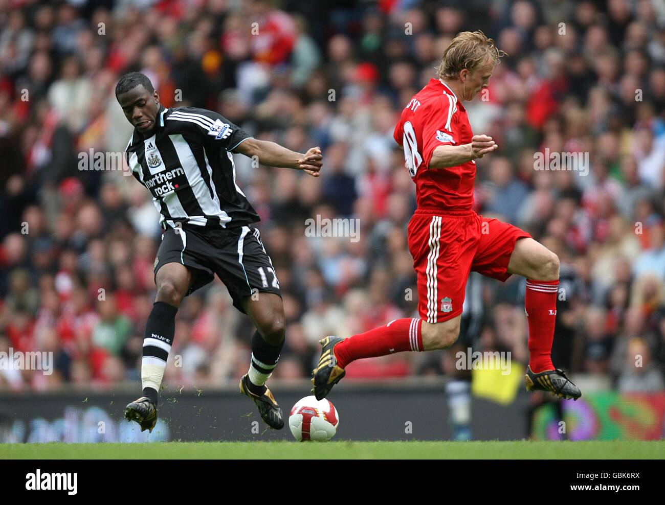 Newcastle United's Sebastien Bassong (left) and Liverpool's Dirk Kuyt ...