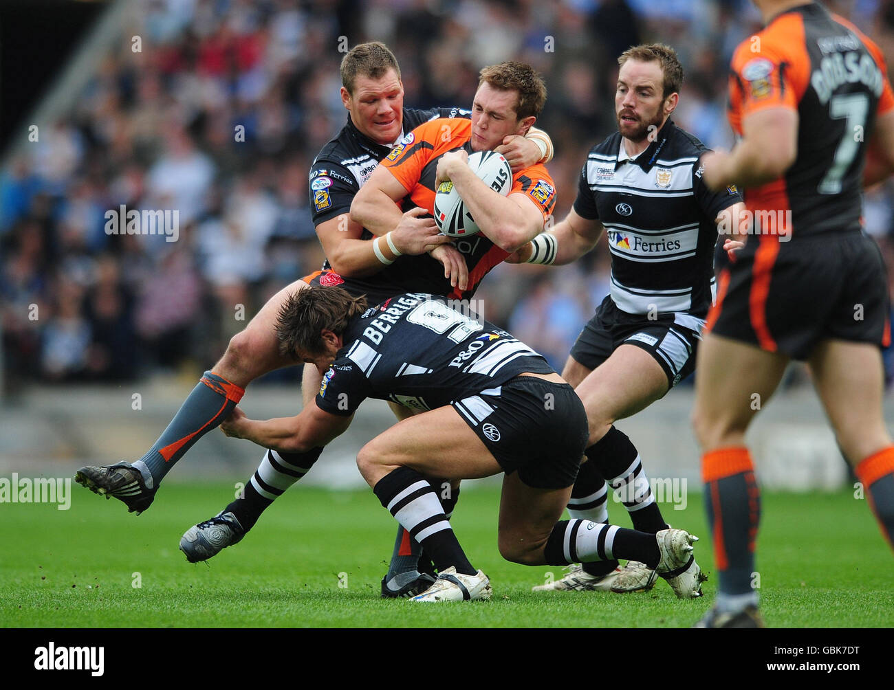 Hull KR's Scott Wheeldon is tackled by Hull FC's Shaun Berrigan and ...