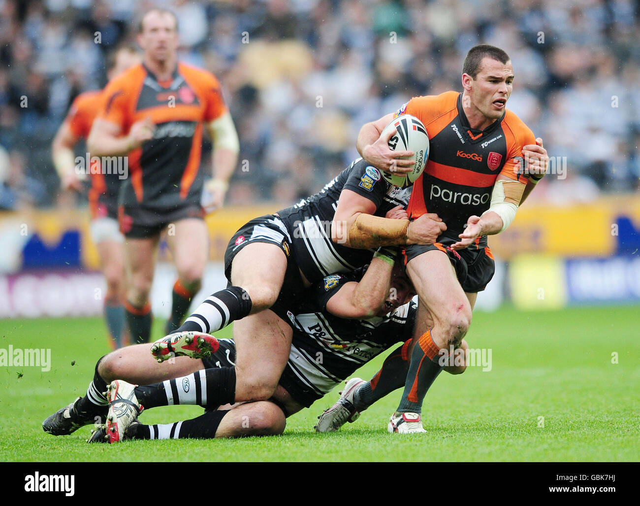 Hull KR's Daniel Fitzhenry is tackled by Hull FC's Jamie Thackray and ...
