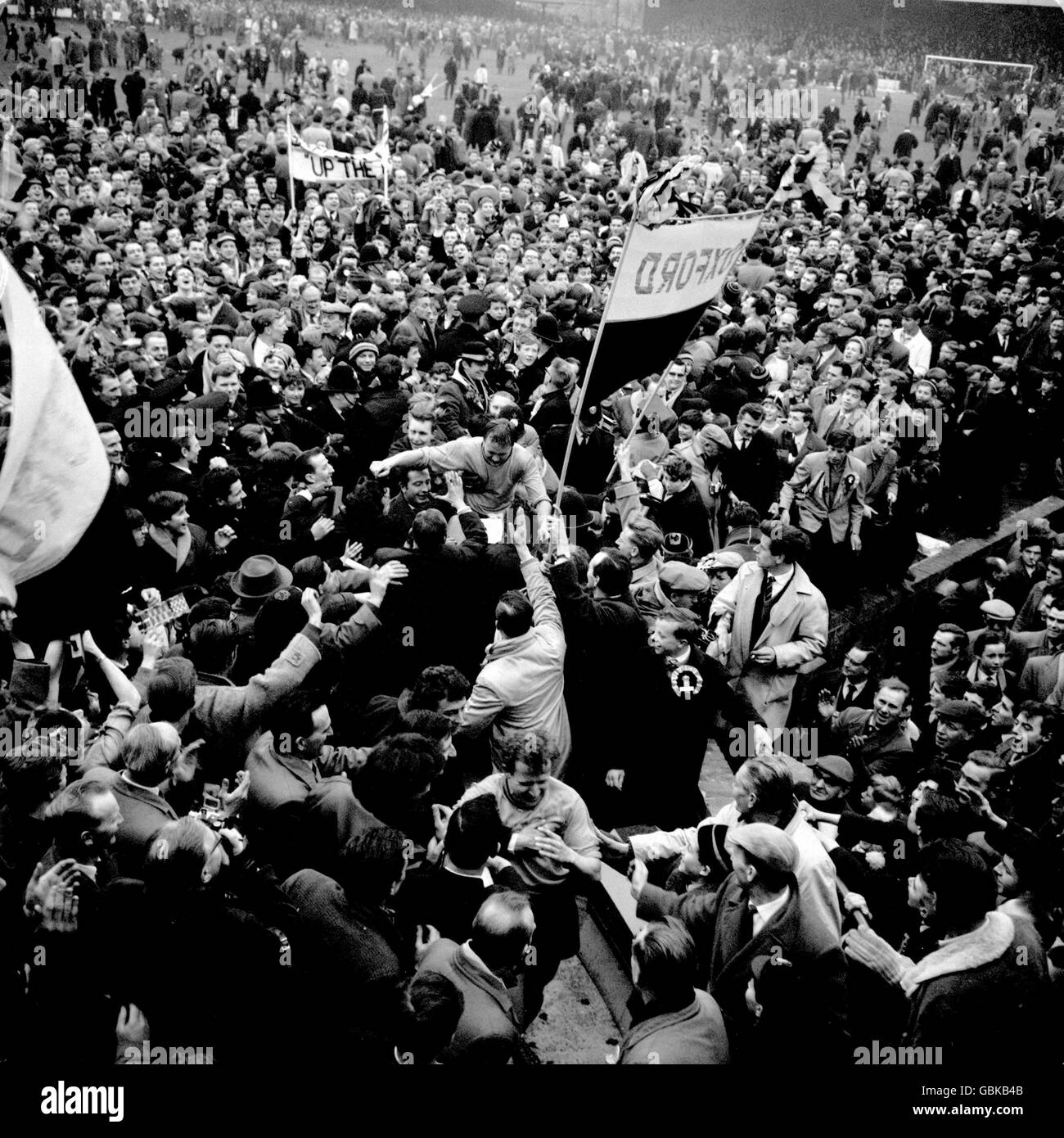 Oxford United captain Ron Atkinson (c) is carried off by euphoric fans ...