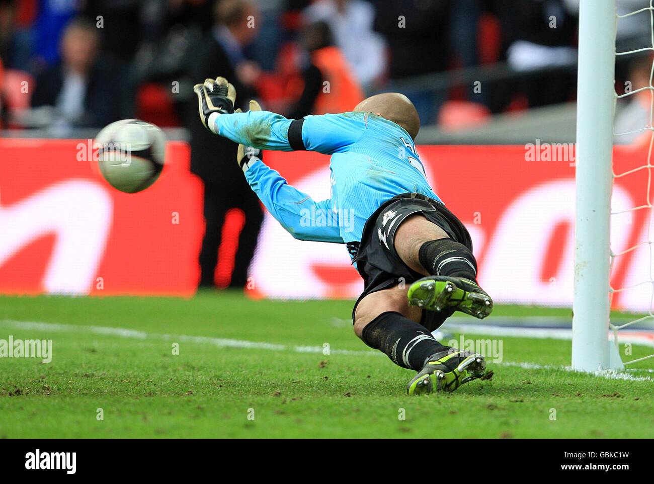 Everton's goalkeeper Tim Howard saves from Manchester United's Rio ...