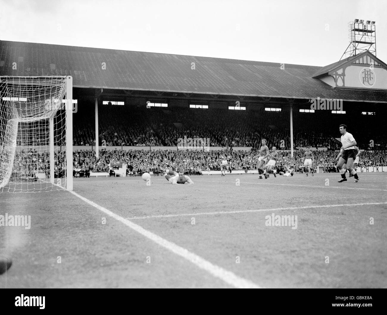 FA Select XI goalkeeper Ron Springett (l) dives for the ball as it ...