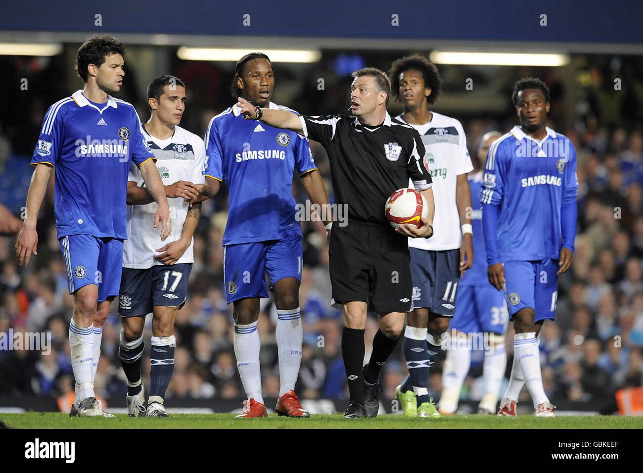 Players surround the referee while Chelsea's Didier Drogba (centre left ...