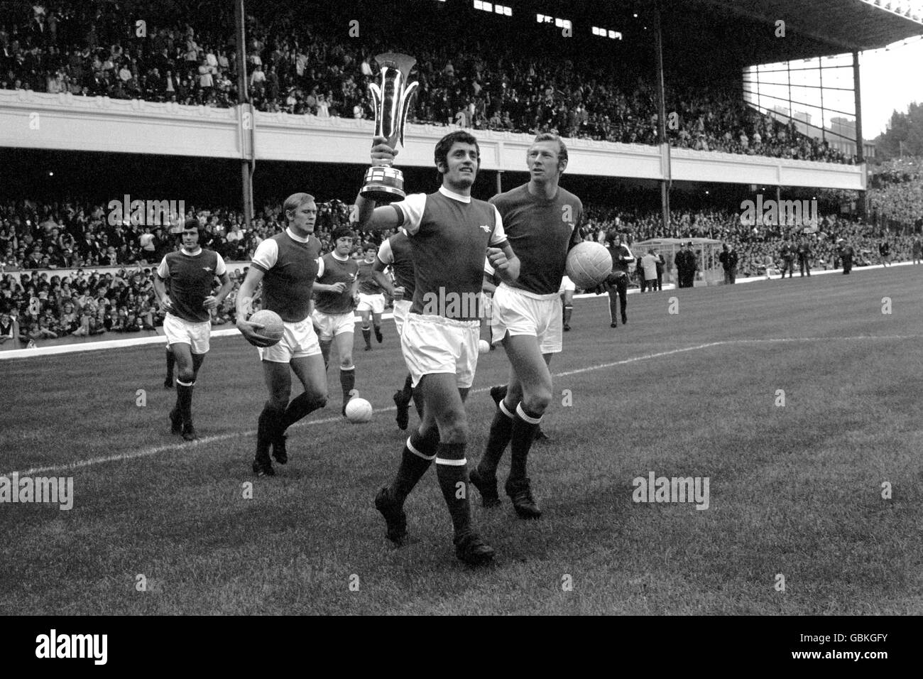 Arsenal captain Frank McLintock (second r) shows off the Inter-Cities ...