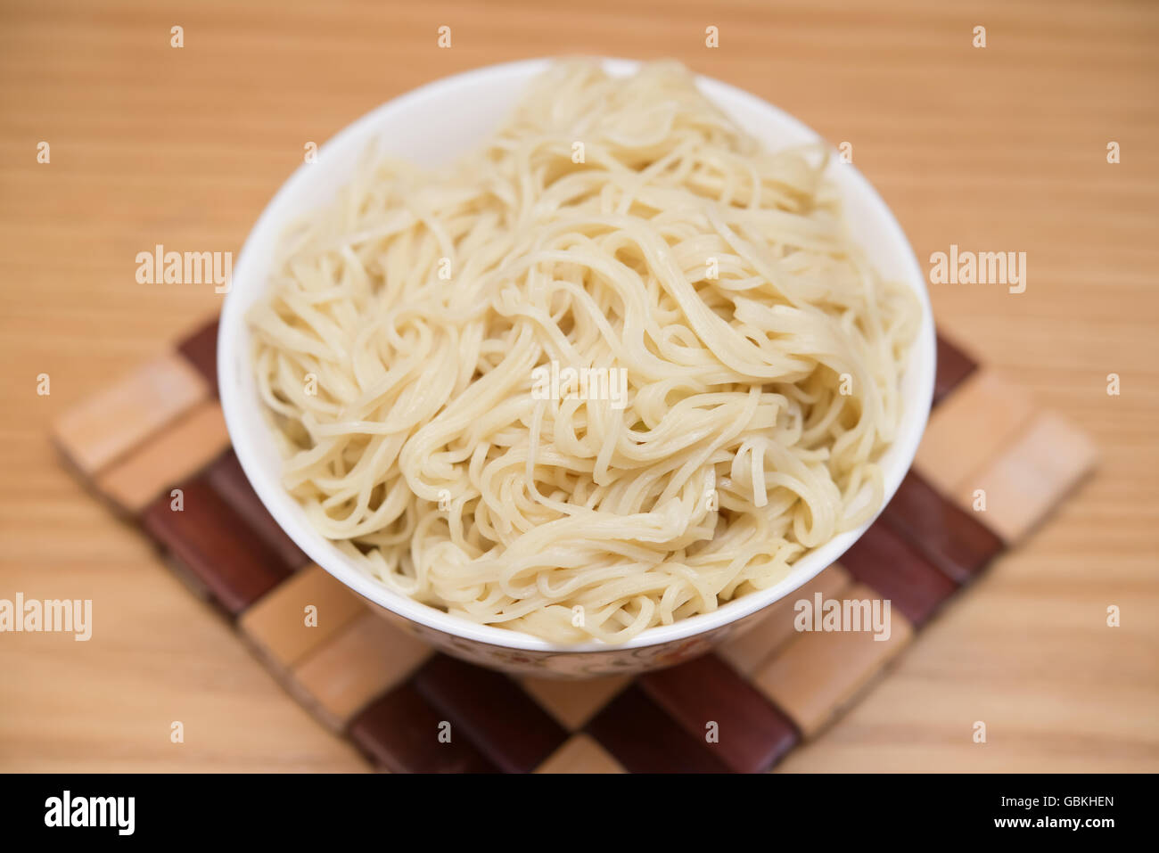 bowl of noodles on a wood table Stock Photo - Alamy