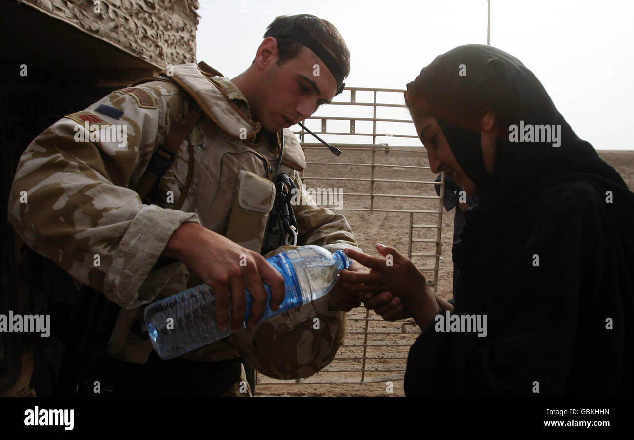 A member of 15 Squadron RAF Regiment gives first aid to a girl who hurt ...
