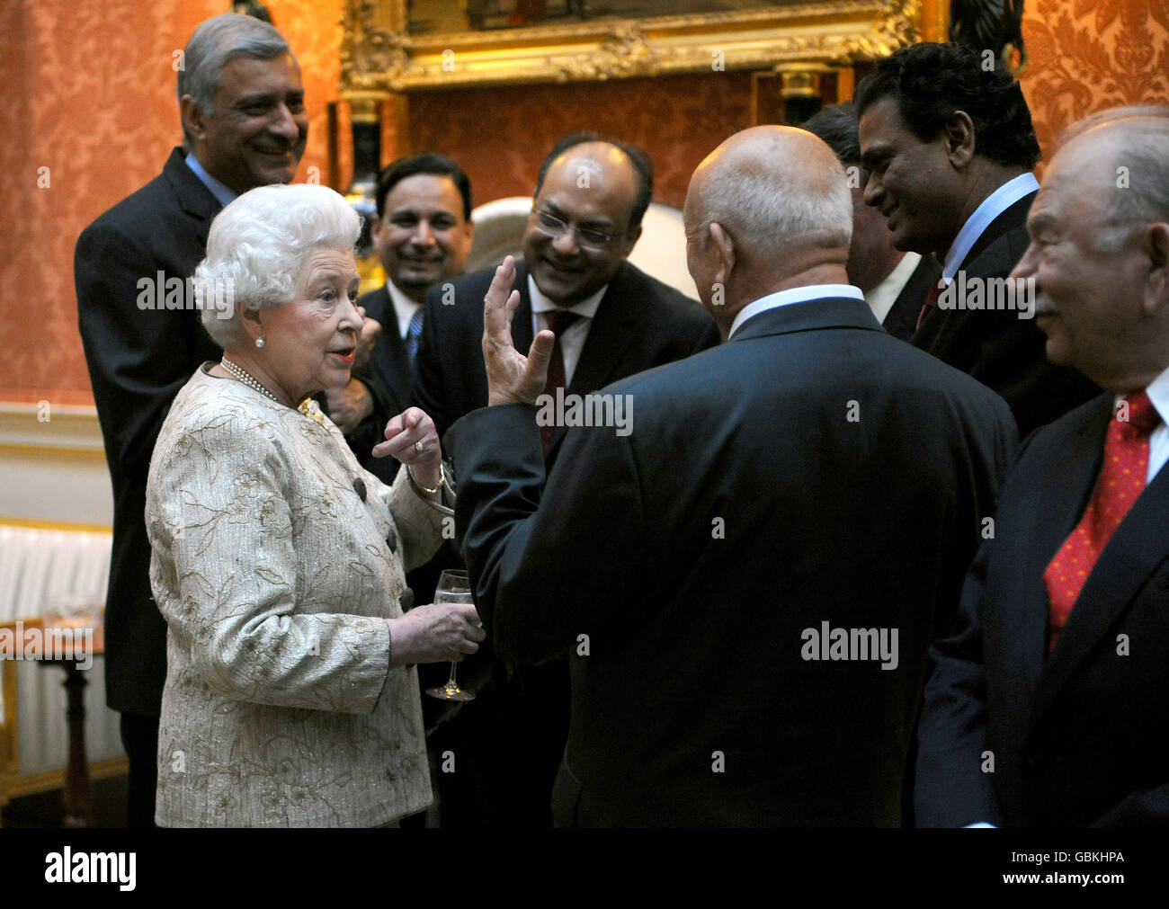 Britain's Queen Elizabeth II speaks with guests as she hosts a ...