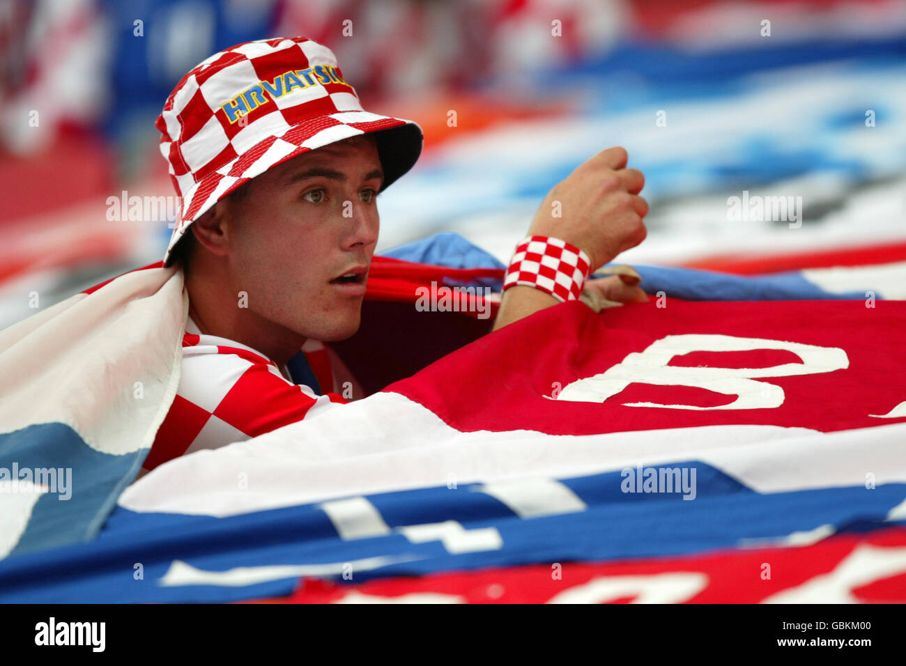 A Croatia fan tries to find his seat under the supporters flags Stock ...