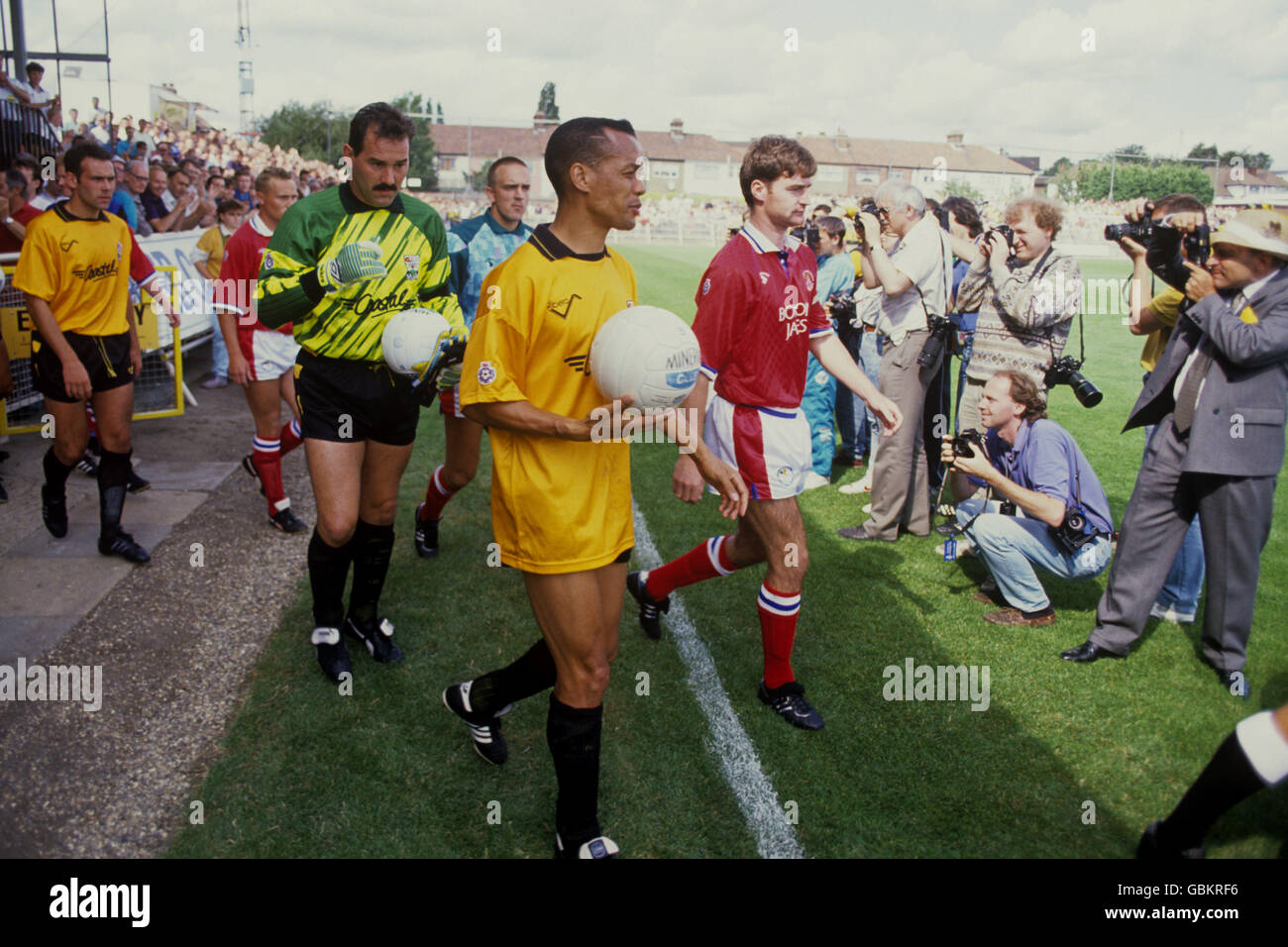 The two teams make their way out on to the pitch. Edwin Stein (c) and ...