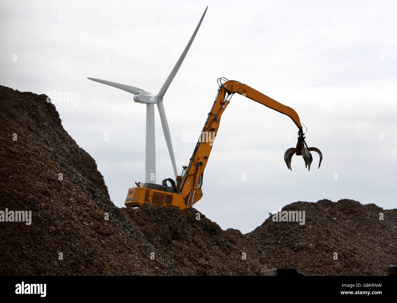 A digger sits on top of a mass of scrap metal at Liverpool docks. The ...