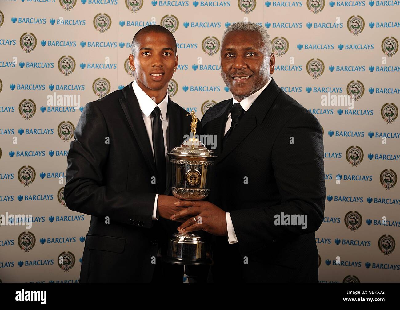 Ashley Young with his agent Ricky Hill (r) receiving the trophy for ...