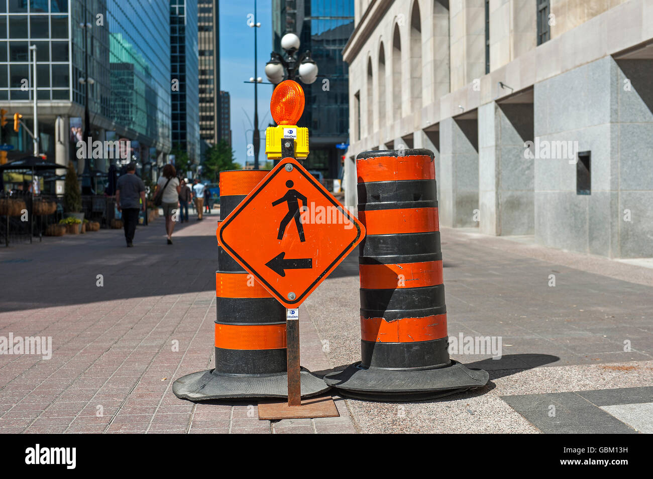 road sign pointing left around pilons Stock Photo - Alamy