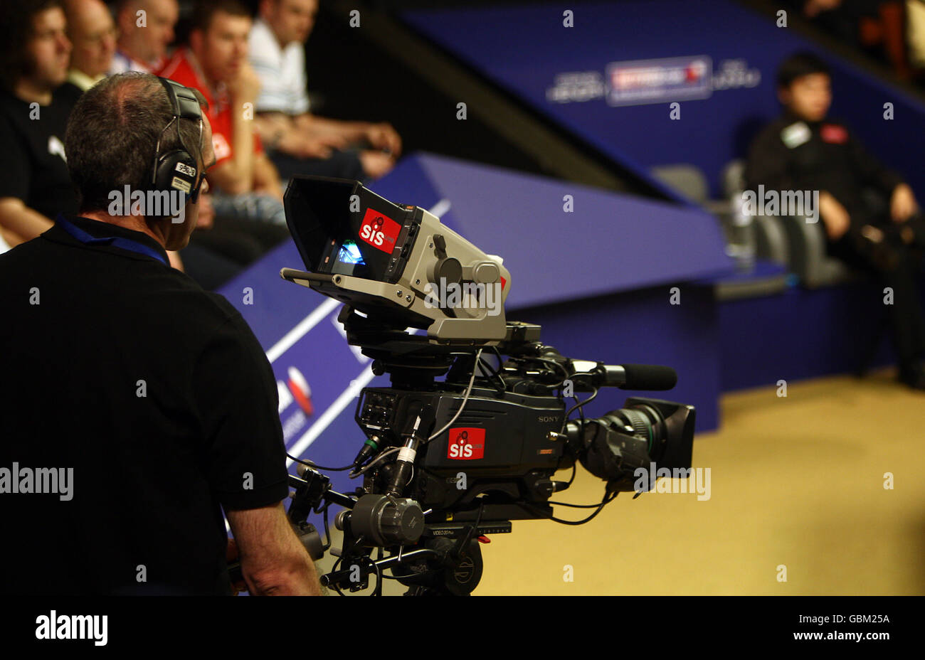 General view of an SIS Sony cameraman and camera filming the action ...