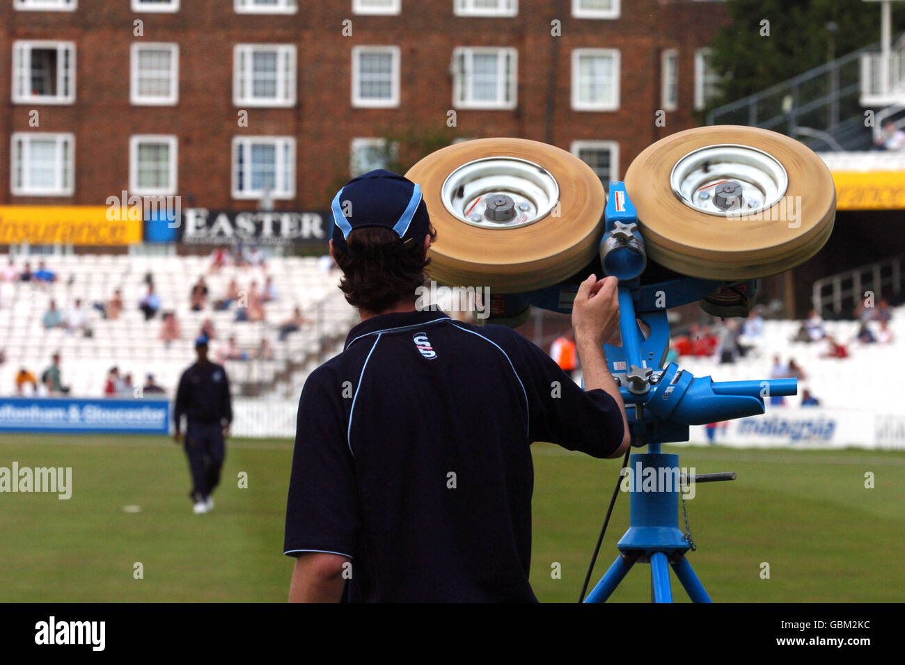 Surrey players use a ball throwing machine to practice their fielding ...