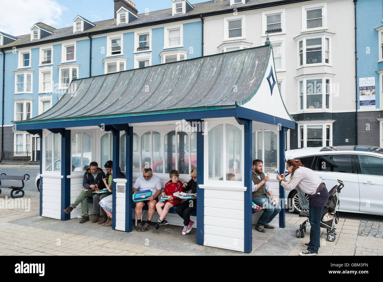 Family eating take away,take out fish and chips from local chippy at ...