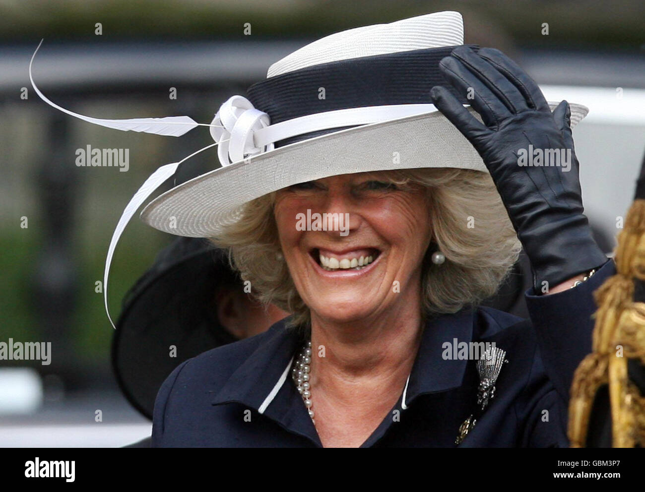 The Duchess of Cornwall holds on to her hat in the wind, as she leaves ...