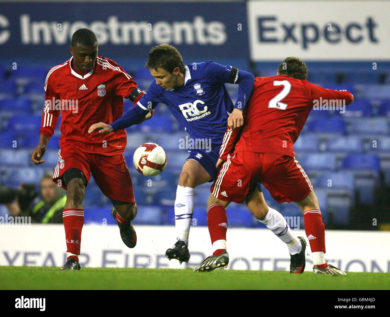 Birmingham City's Jamie Sheldon is tackled by Liverpool's David Amoo ...