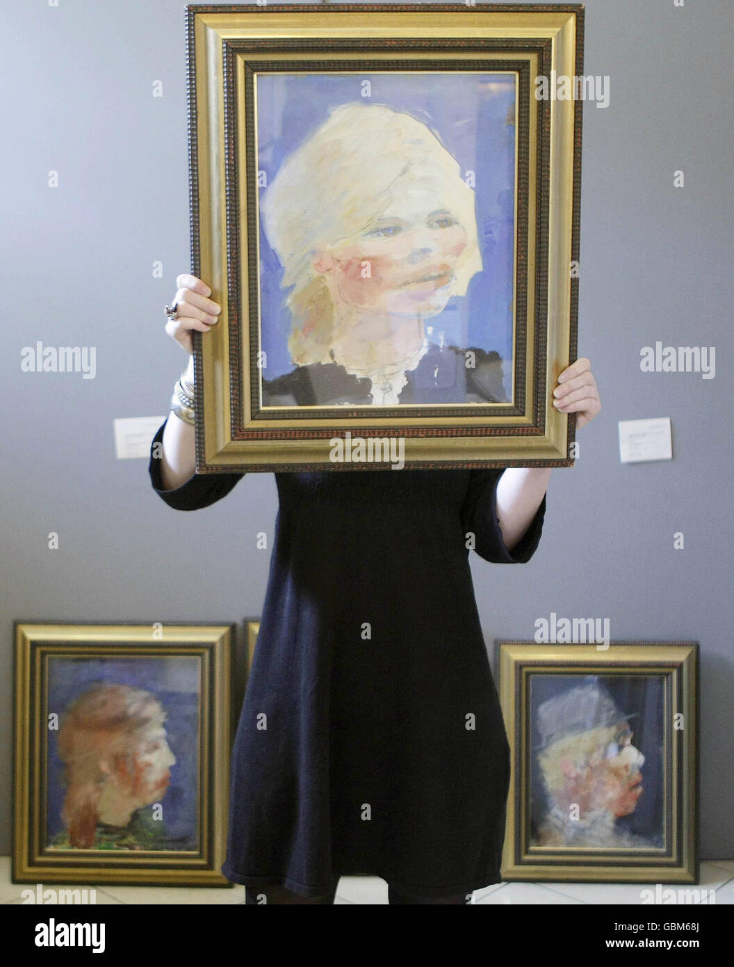 Harriet Patterson of Christie's prepares to hang a painting from the ...