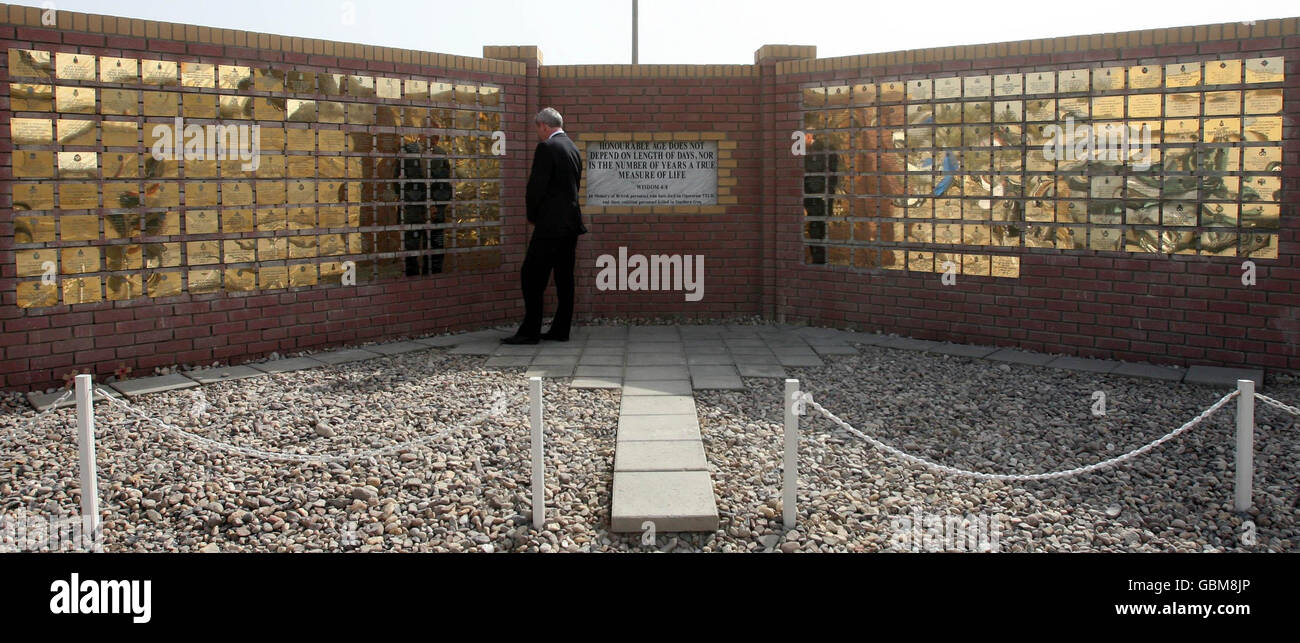 Defence Secretary John Hutton looks at the memorial wall in Basra after ...