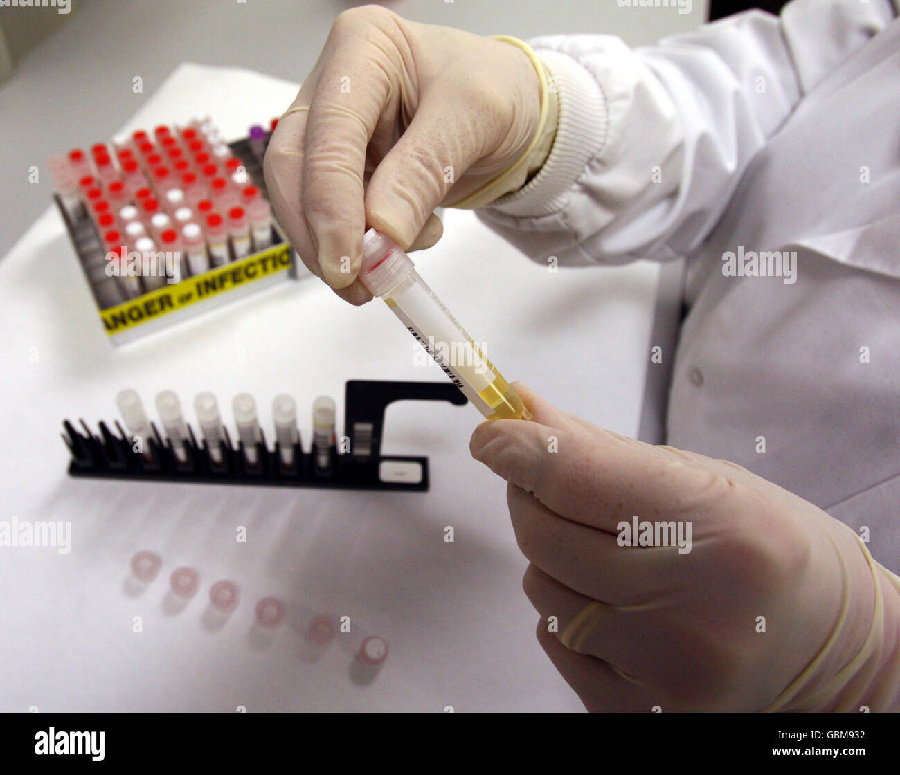 A scientist handles viral samples at the West of Scotland Specialist ...