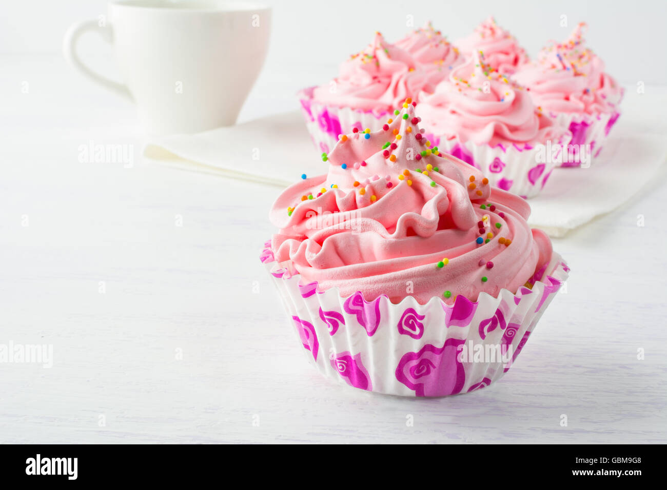 Pink delicious cupcakes and cup of tea. Birthday cupcakes. Homemade ...
