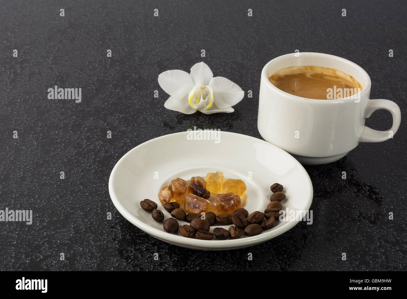 Romantic coffee cup and white orchid on the black background. Coffee ...