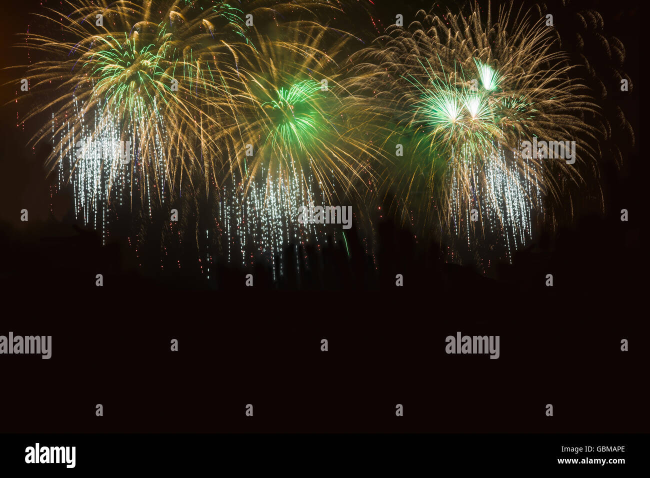 Golden and green fireworks over night sky. Celebration colorful ...