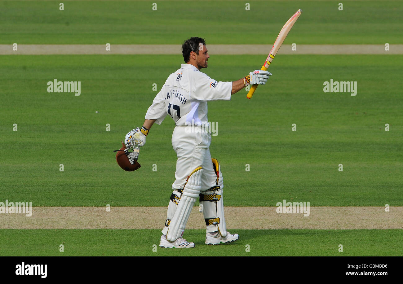 Surrey's Mark Ramprakash raises his bat to the pavilion to celebrate ...