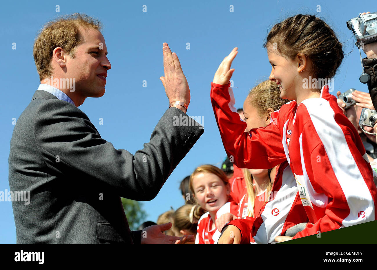 Prince William (left) gives Lorna Bradnock, 11, (right) during a visit ...
