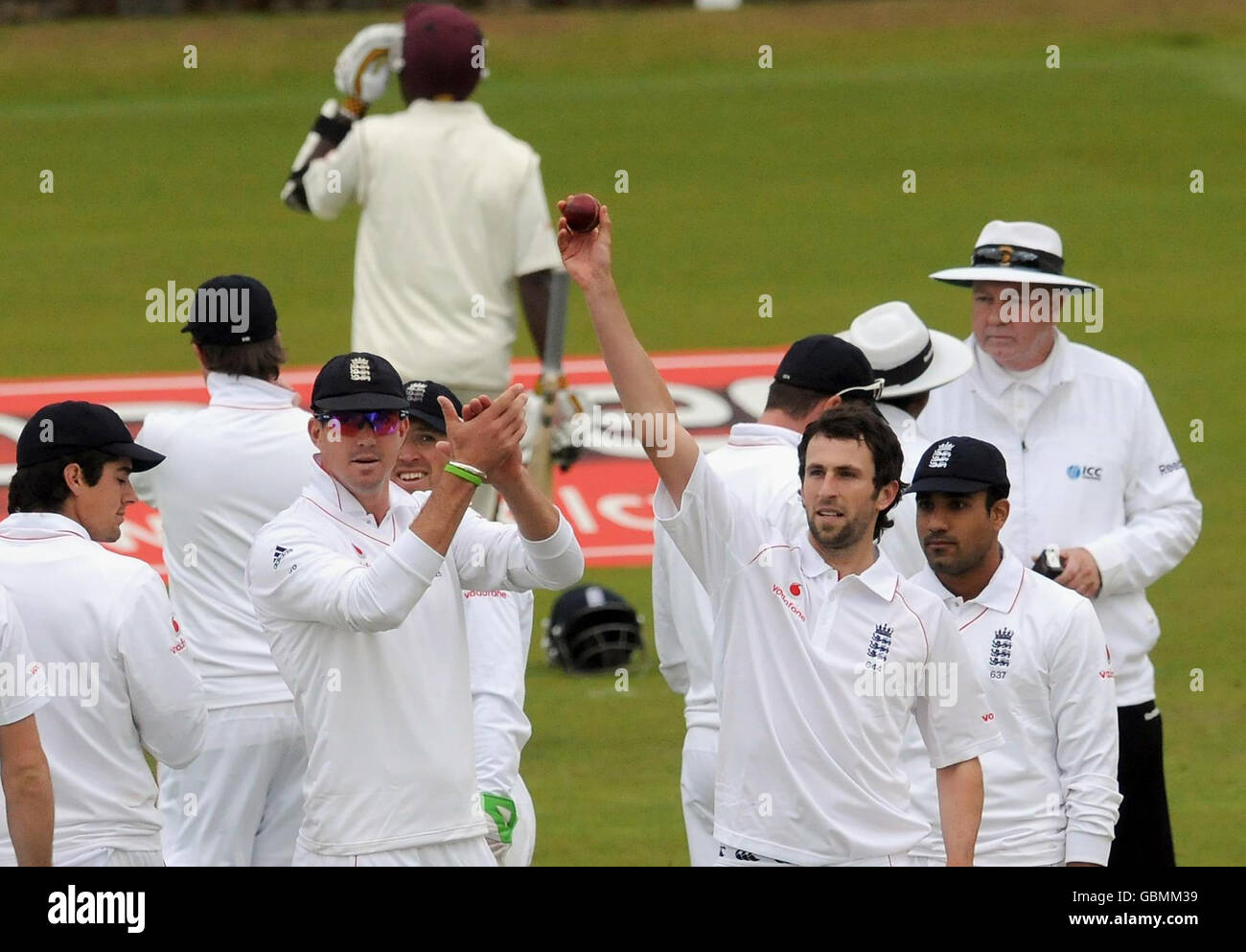 England's Graham Onions holds the match ball aloft after taking five ...