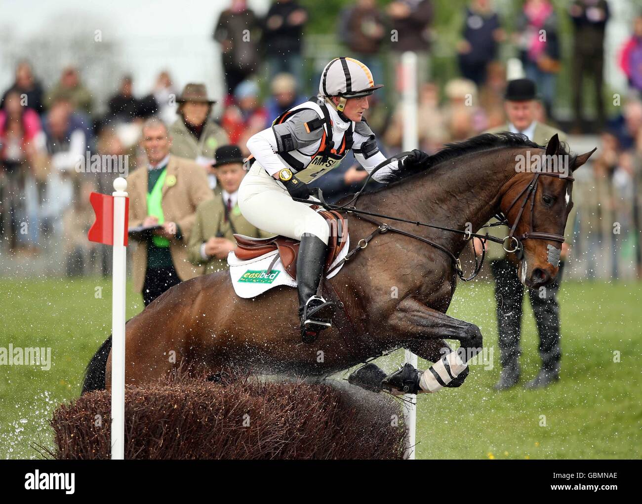 Ruth Edge riding Mayhem II jumps through the lake during the cross ...