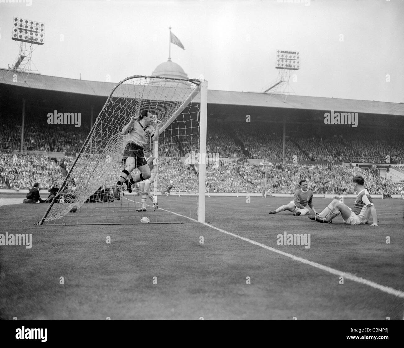 Wolverhampton Wanderers' Norman Deeley (l) celebrates in the net as ...