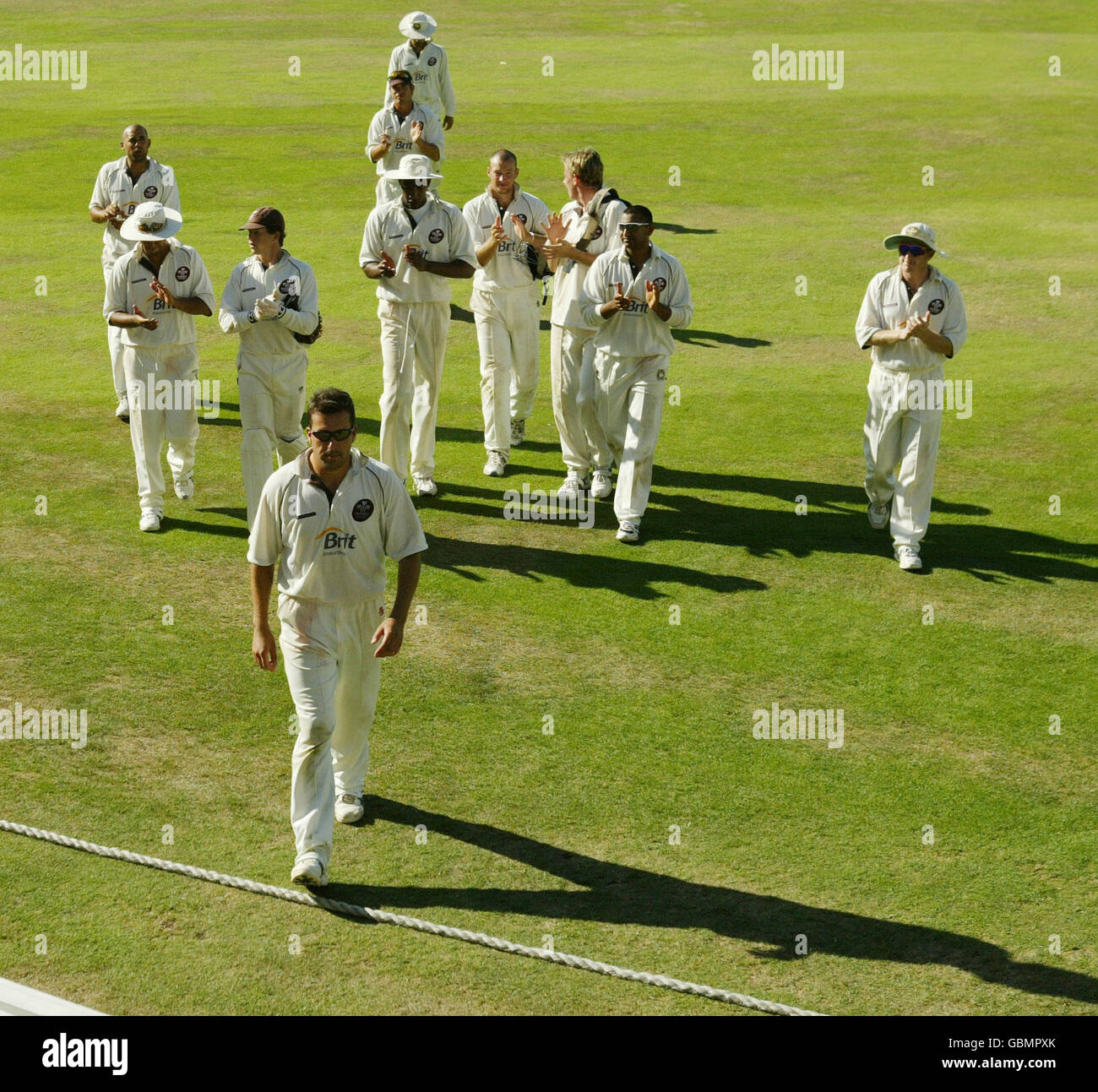Jimmy Ormond is applauded off the field by his Surrey team mates after ...
