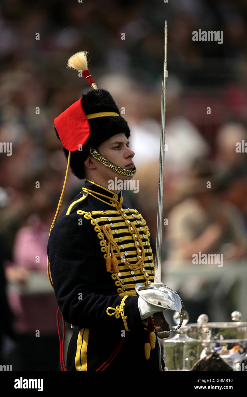 A guard stands next to the trophies during the show jumping competition ...