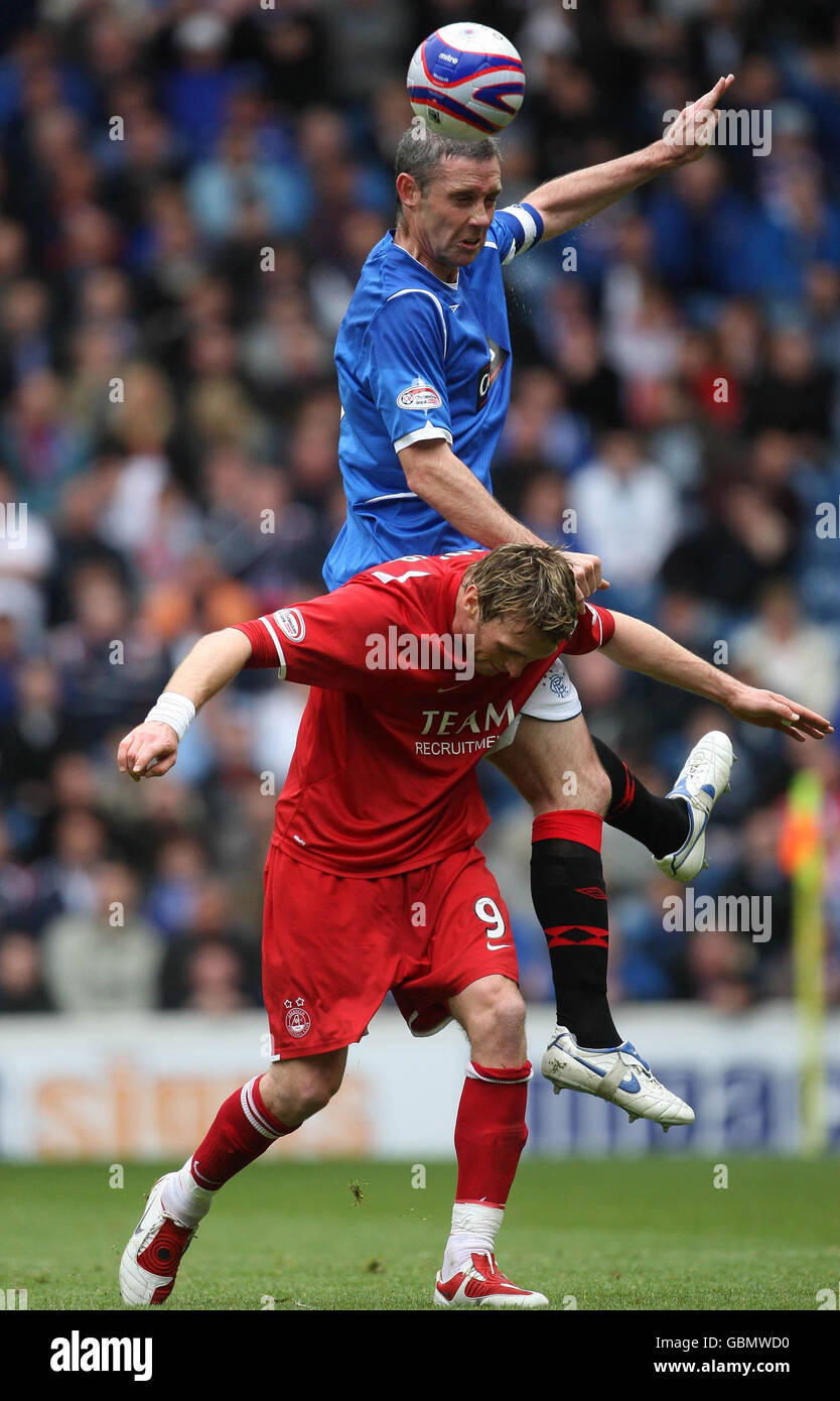 Rangers' David Weir and Aberdeen's Lee Miller (below) battle for a ball ...