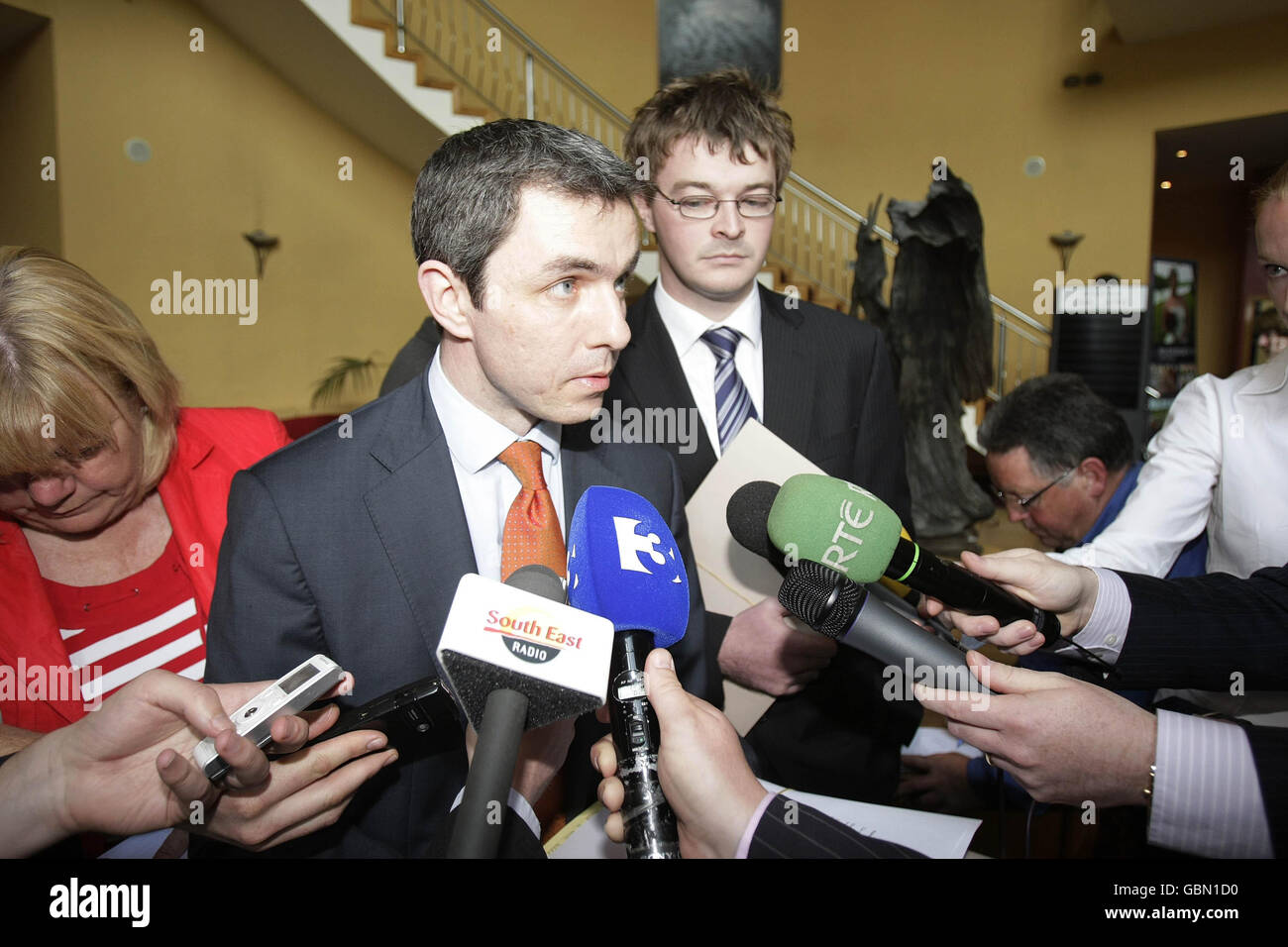 Solicitor Jason Dunne (centre left, of no relation) reads a statement ...