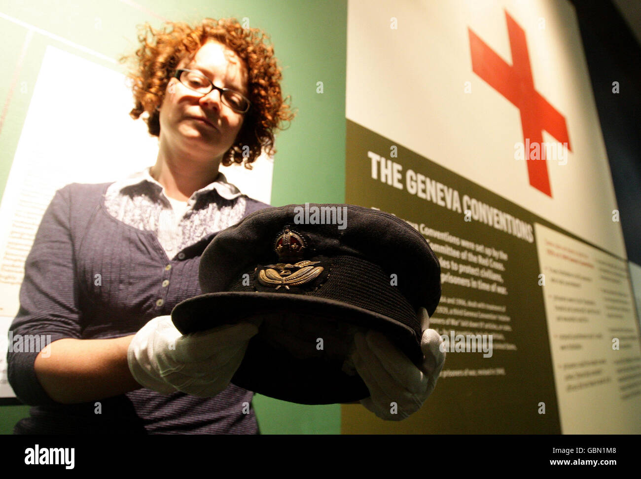 Collections Liaison Officer Amanda Mason, holds the cap worn by Jimmy ...