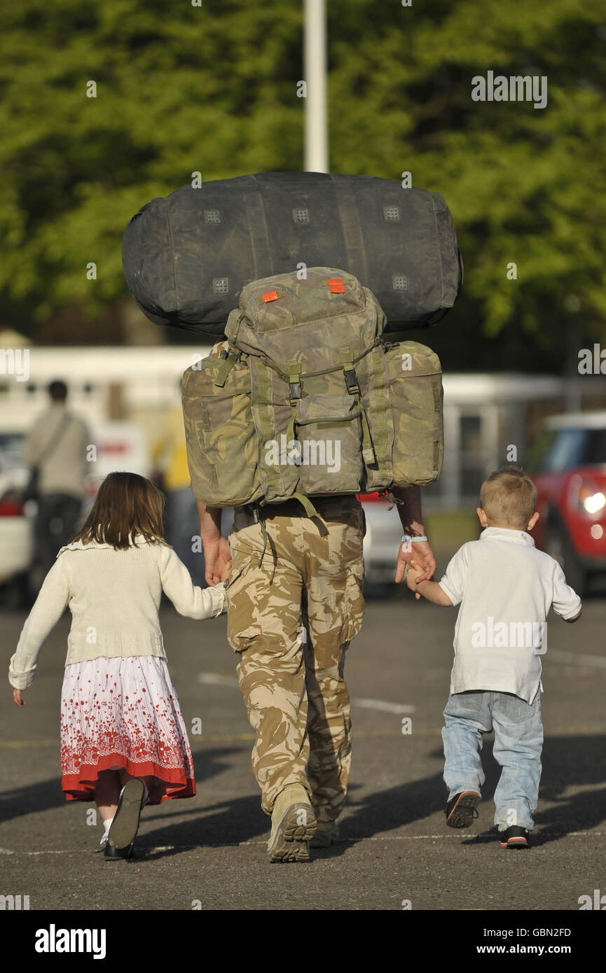 A 1st Battalion Rifle soldier takes his children and bags back to his ...