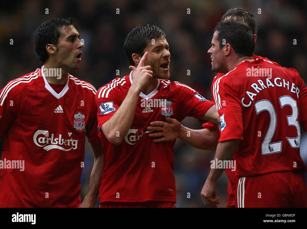 Liverpool's Xabi Alonso (centre) acts as peacemaker after an argument ...
