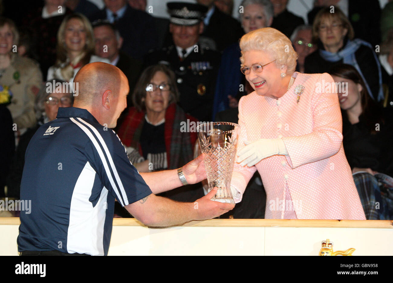 Queen Elizabeth II presents a member of the HMS Portsmouth field gun ...